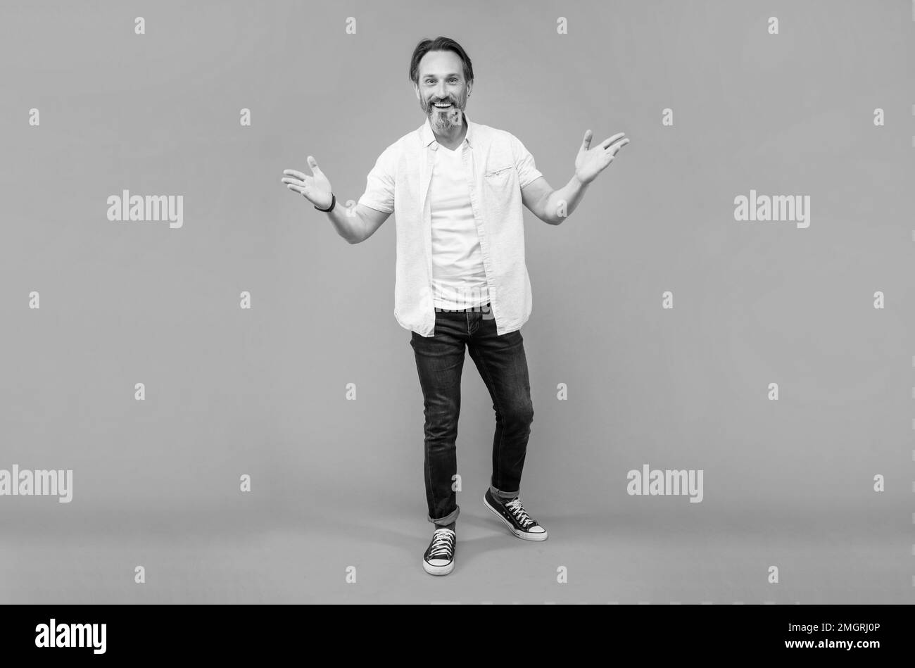 Happy senior man in casual gesticulate with open arms grey background ...
