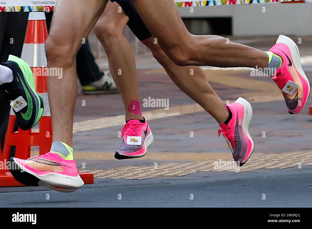 Runners in Nike shoes compete in the Tokyo Marathon in Tokyo, Sunday ...