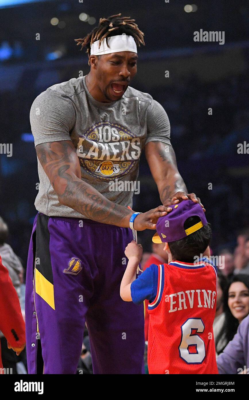 Los Angeles Lakers center Dwight Howard, left, jokes around with Logan ...