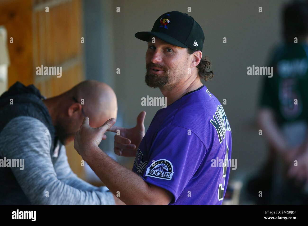 Colorado Rockies' Daniel Murphy pauses in the dugout prior to a spring ...
