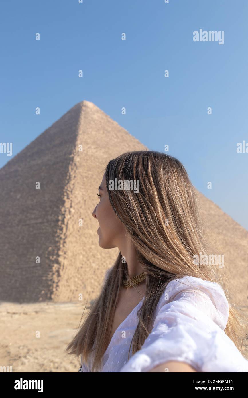 Vertical selfie view of unrecognizable young blond woman taking a ...