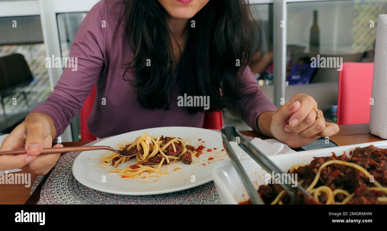 Woman eating pasta spaghetti for lunch Stock Photo - Alamy