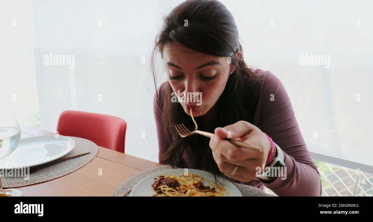 Woman eating pasta spaghetti for lunch Stock Photo - Alamy