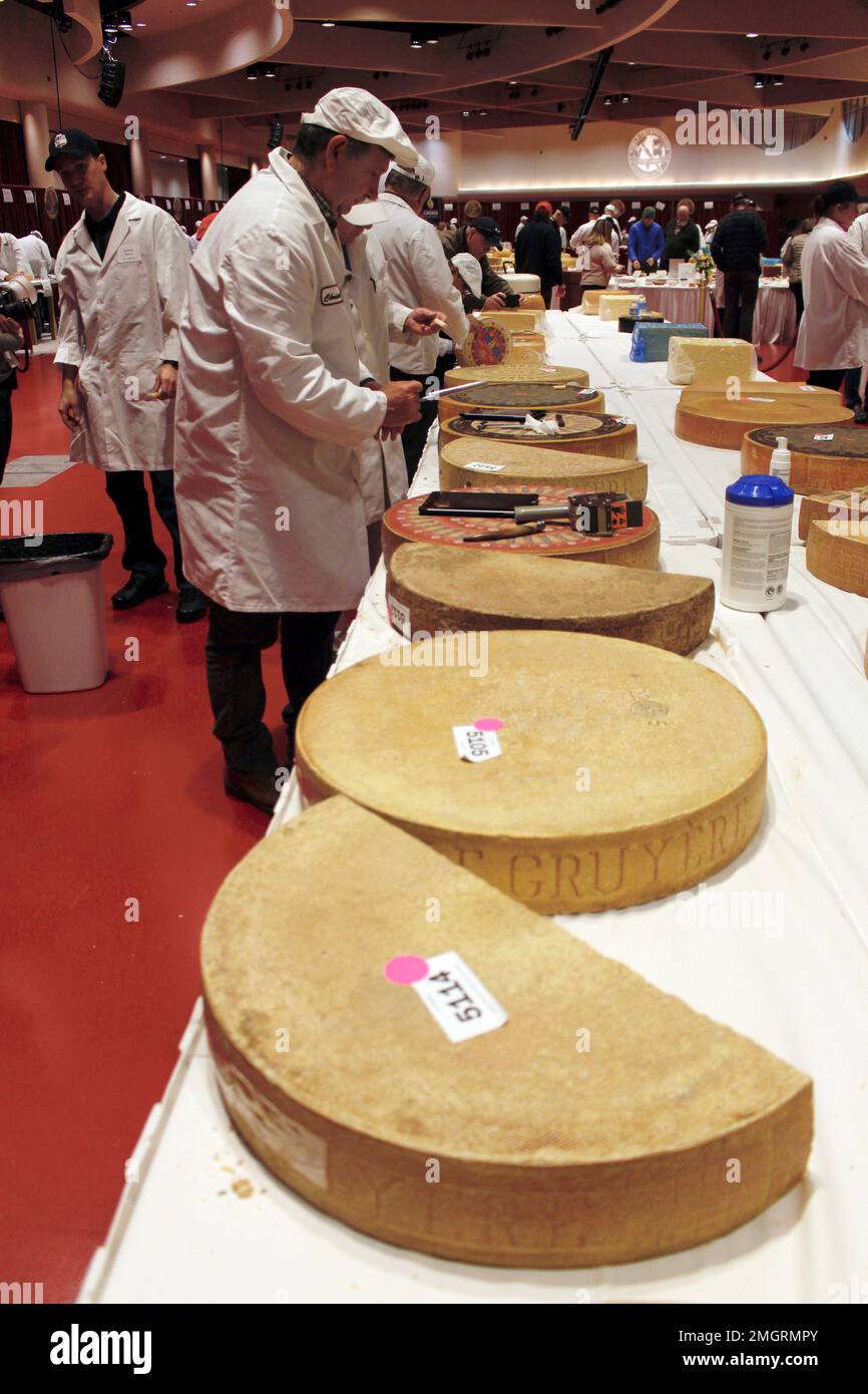 Judge Christophe Megevand inspects a wheel of Gruyere cheese at the ...