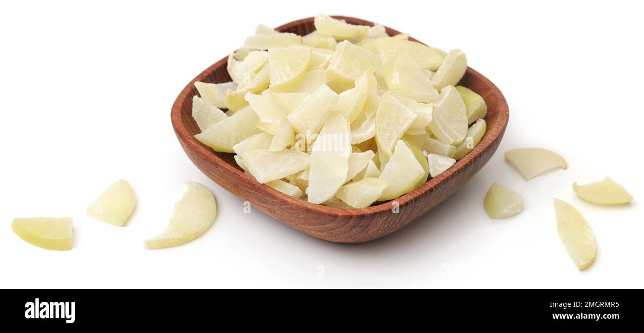 Sliced amla fruits in a bowl over white background Stock Photo - Alamy