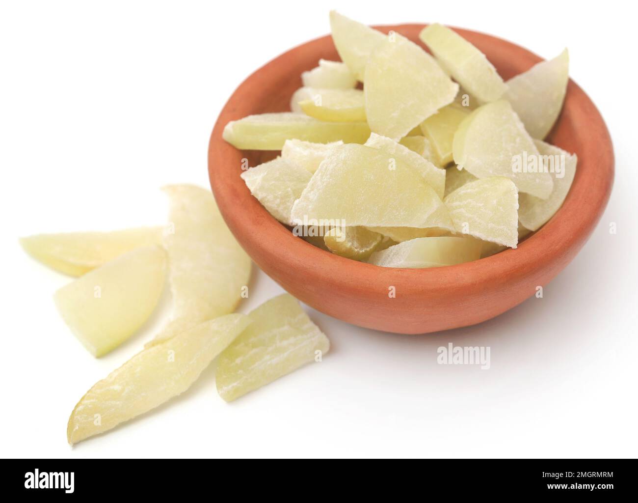 Sliced amla fruits in a bowl over white background Stock Photo - Alamy
