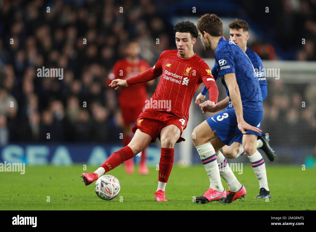 Liverpool's Curtis Jones, left, is challenged by Chelsea's Marcos ...