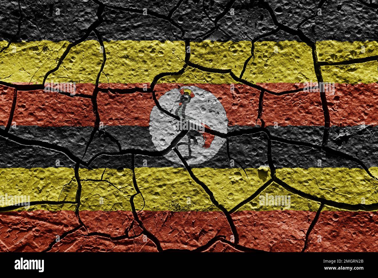 Uganda flag on a mud texture of dry crack on the ground Stock Photo - Alamy