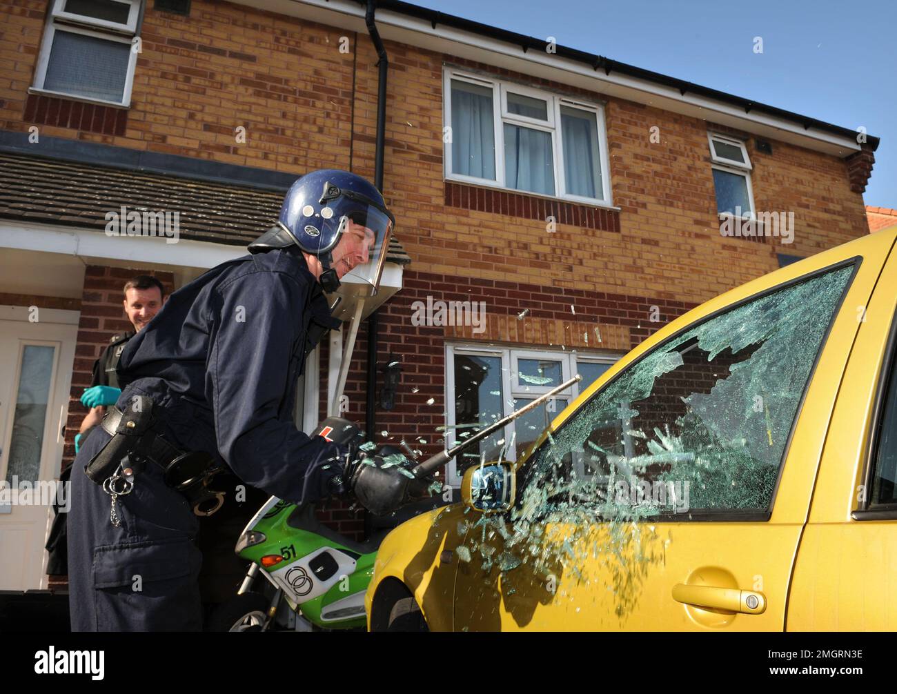 Police officers from the operational team break into a suspects car in ...