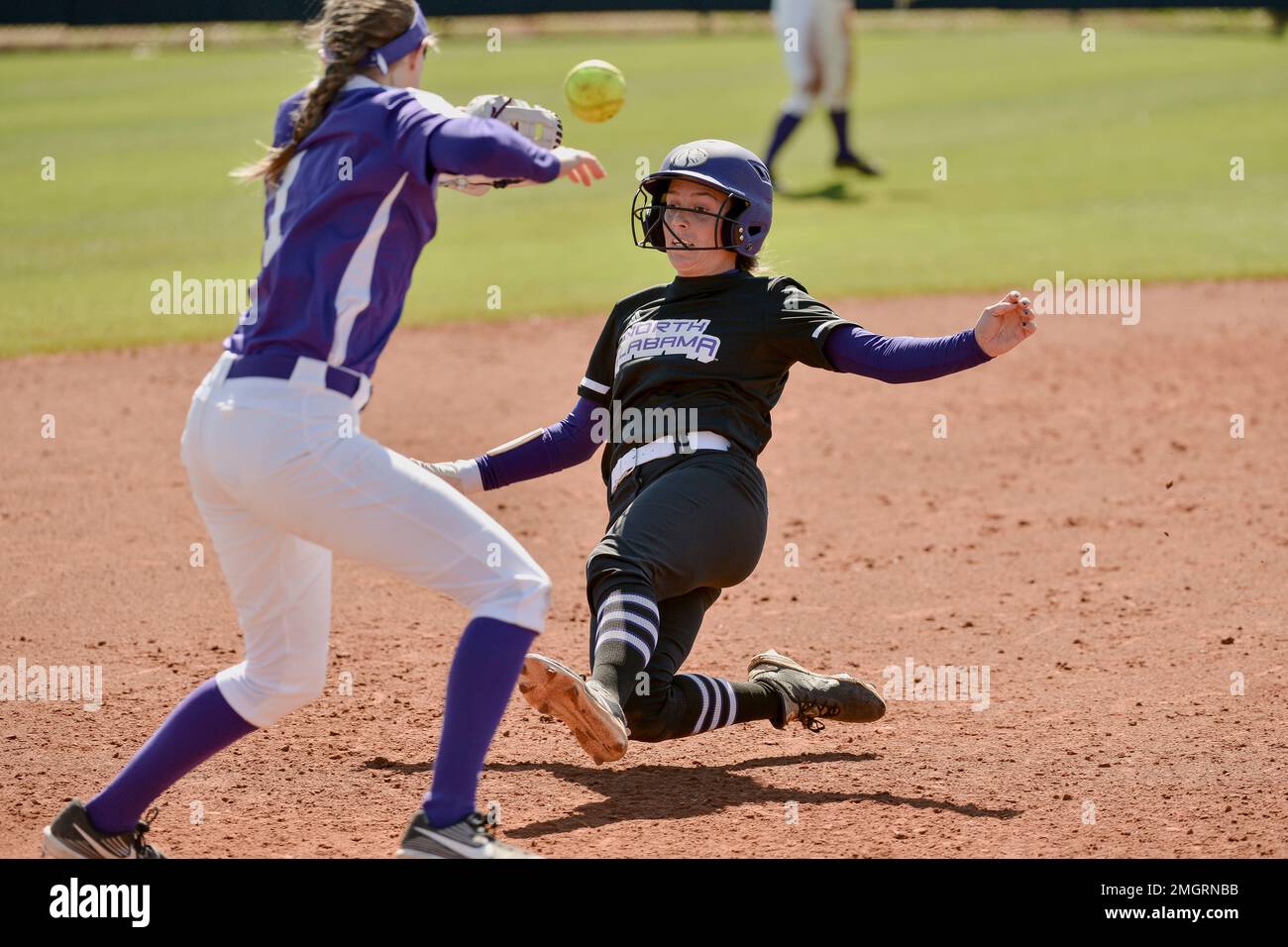 North Alabama's Mary Grayson Kilpatrick slides into third base as ...