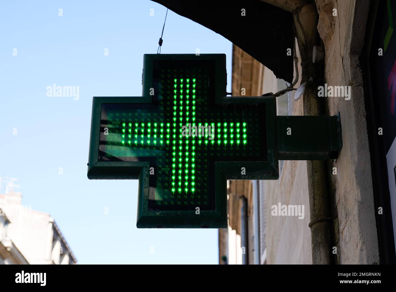 pharmacy sign green cross logo lighting on wall building facade Stock ...