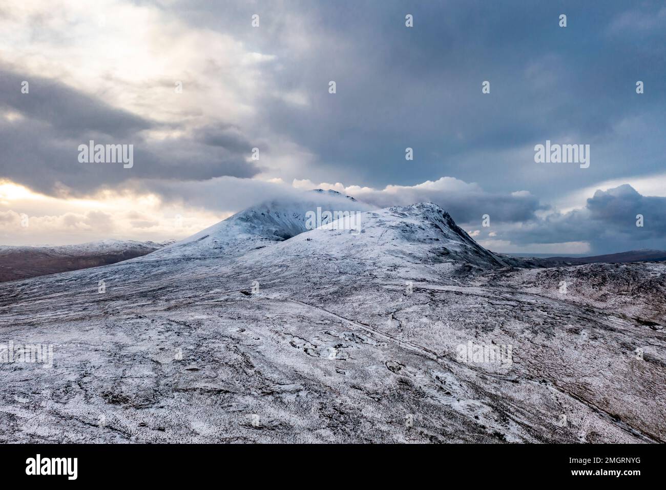 Aerial view of the snow covered Mount Errigal, the highest mountain in ...
