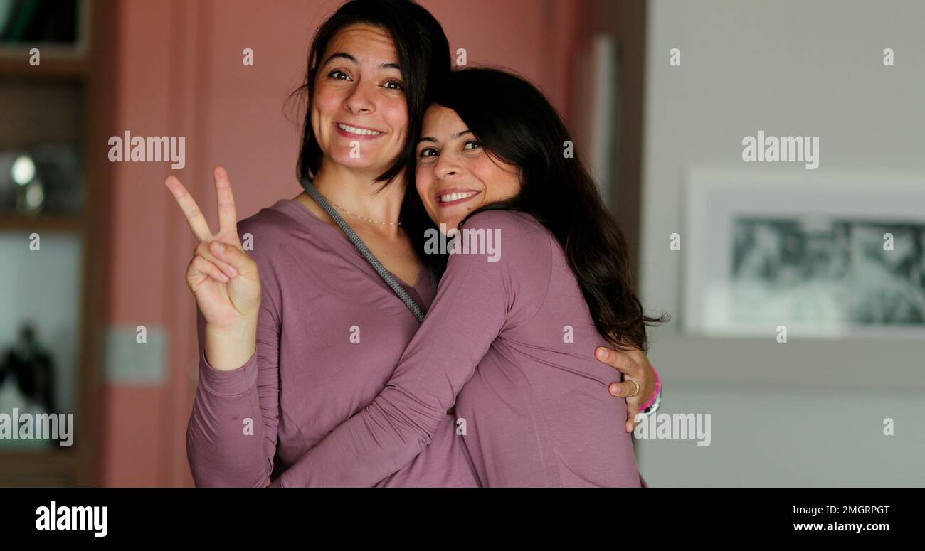 Two adult sisters hugging each other women family love and affection Stock Photo - Alamy