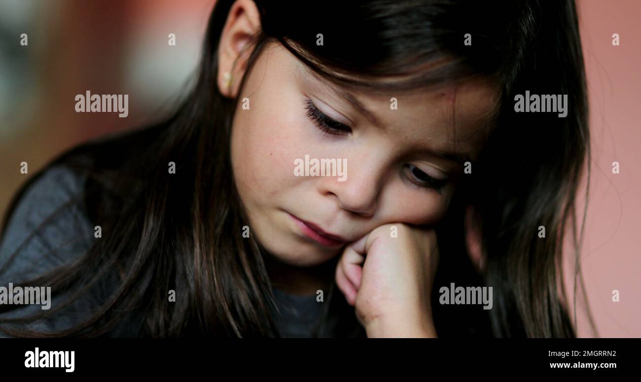 Troubled child sad kid depressed little girl Stock Photo - Alamy