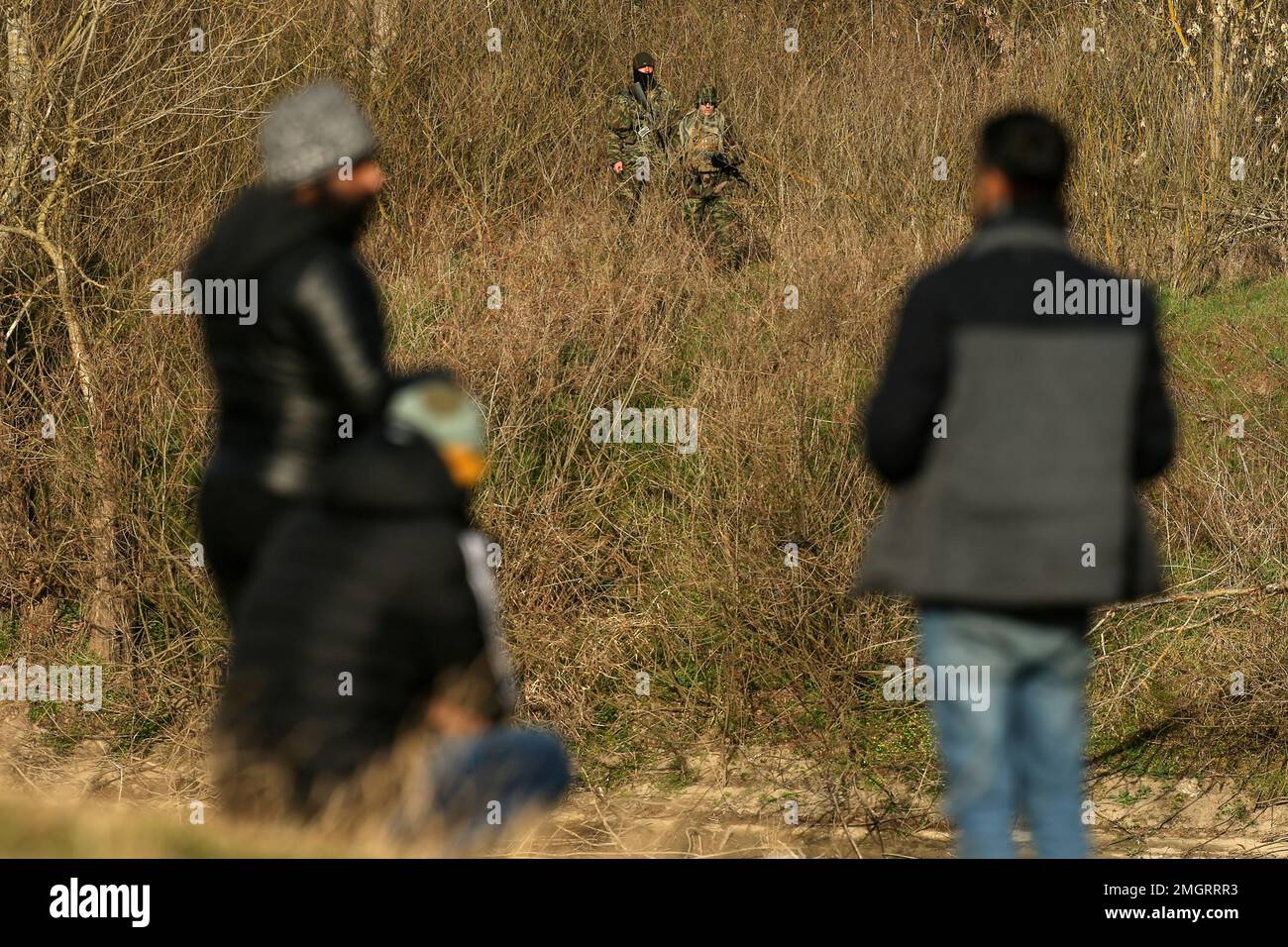 Greek soldiers watch migrants gather at Maritsa river (Evros river in ...