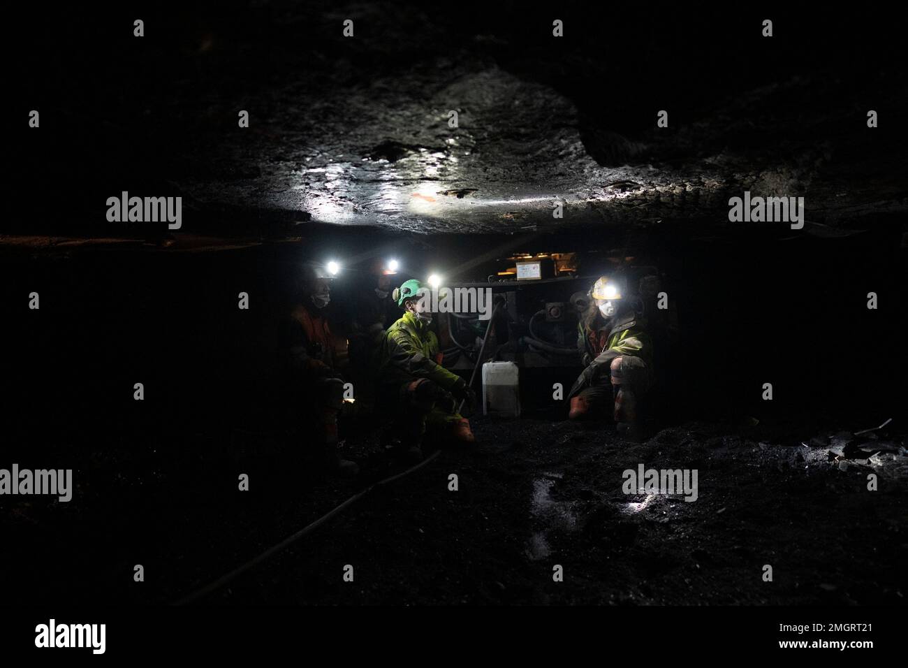 Coal miners refill a machine with oil at the bottom of the Gruve 7 coal ...