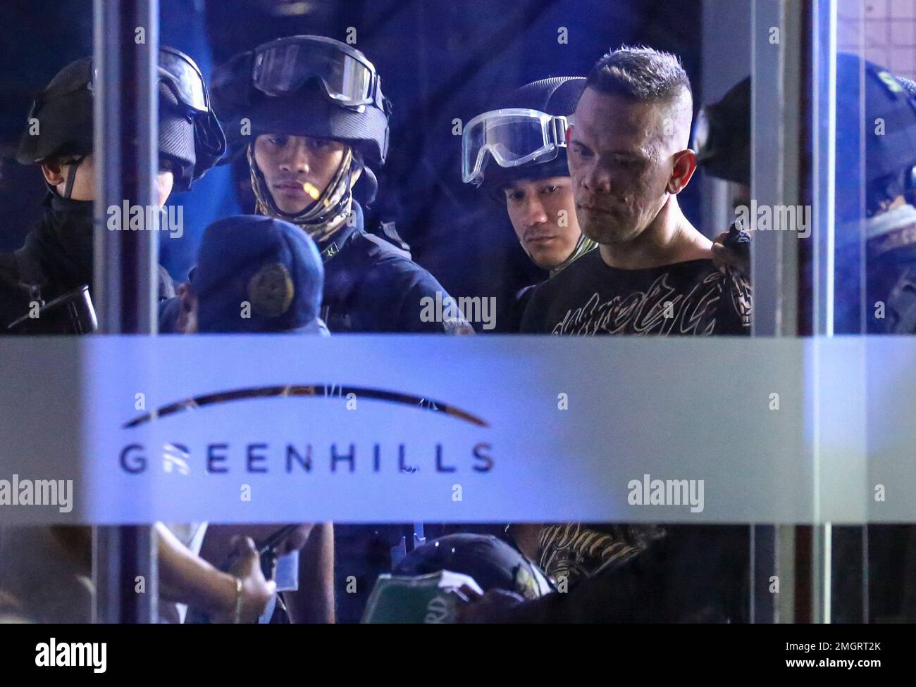 Former security guard Alchie Paray, right, is escorted after his arrest ...