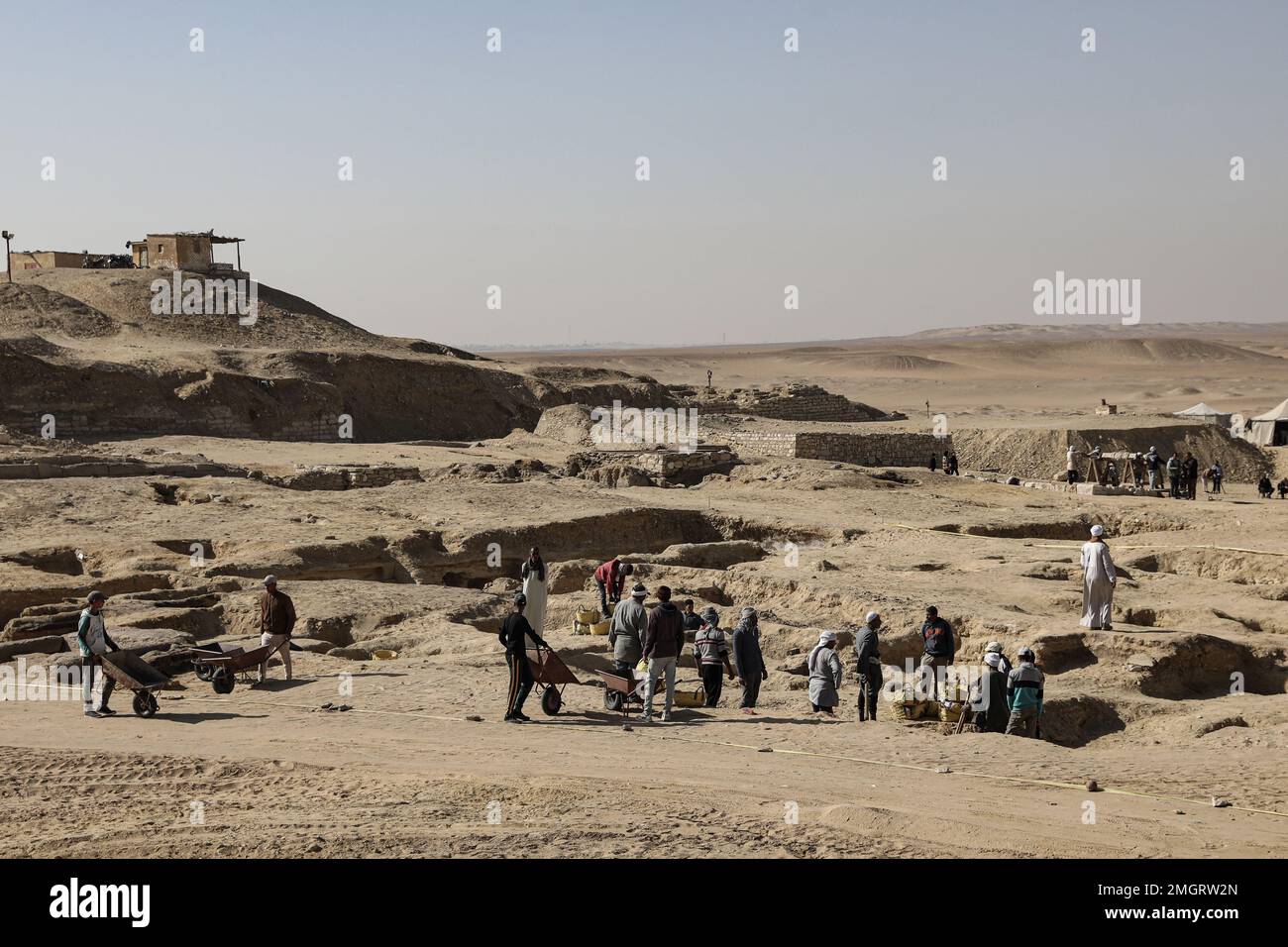 Giza, Egypt. 26th Jan, 2023. Egyptian antiquities workers dig at the ...
