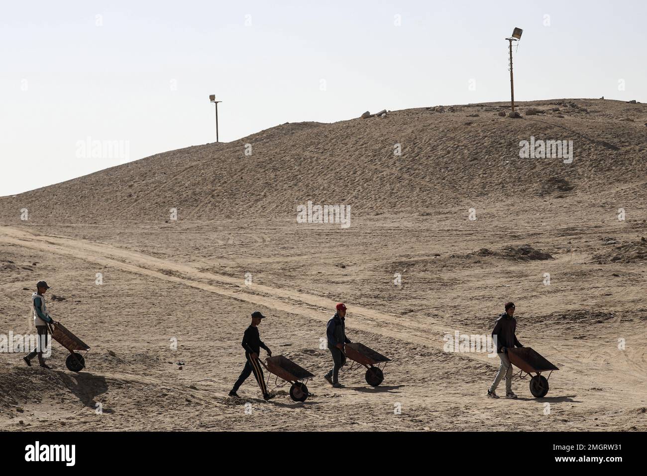 Giza, Egypt. 26th Jan, 2023. Egyptian antiquities workers dig at the ...