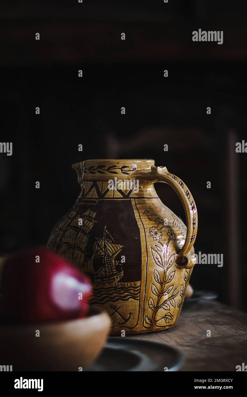 Old fashioned jug. Vintage still life image with dark background and ...
