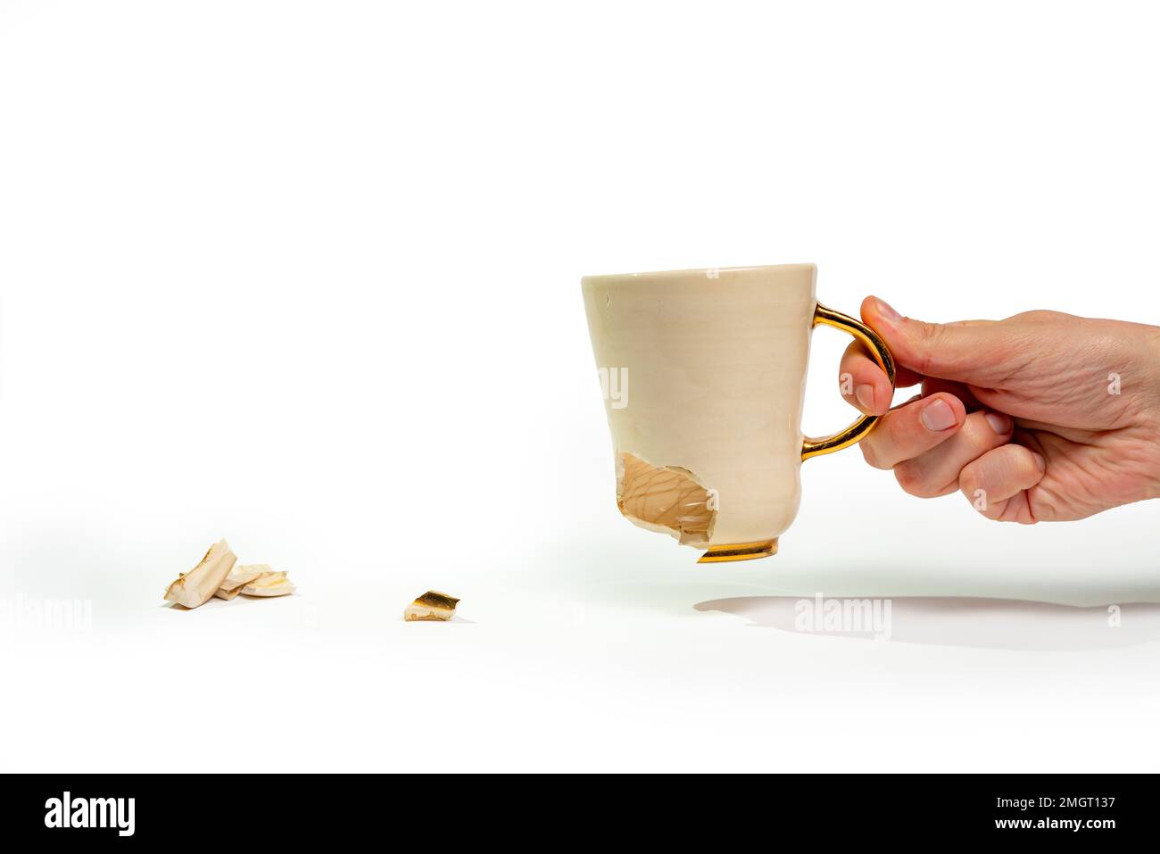 Man holding broken tea cup isolated on white background. Close up of ...