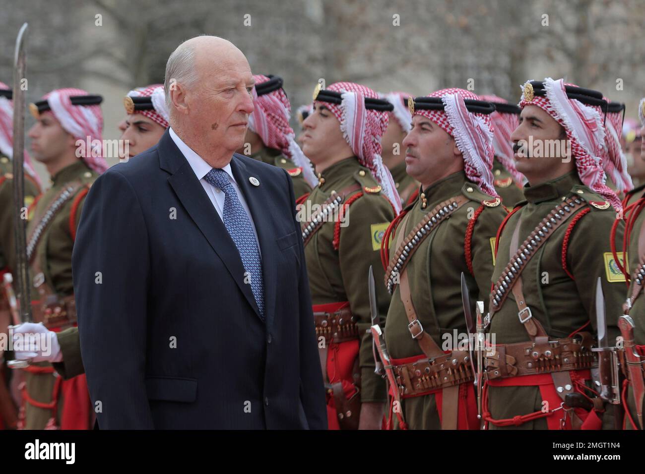 Norway's King Harold, reviews an honor guard at the Husayniyah Palace ...