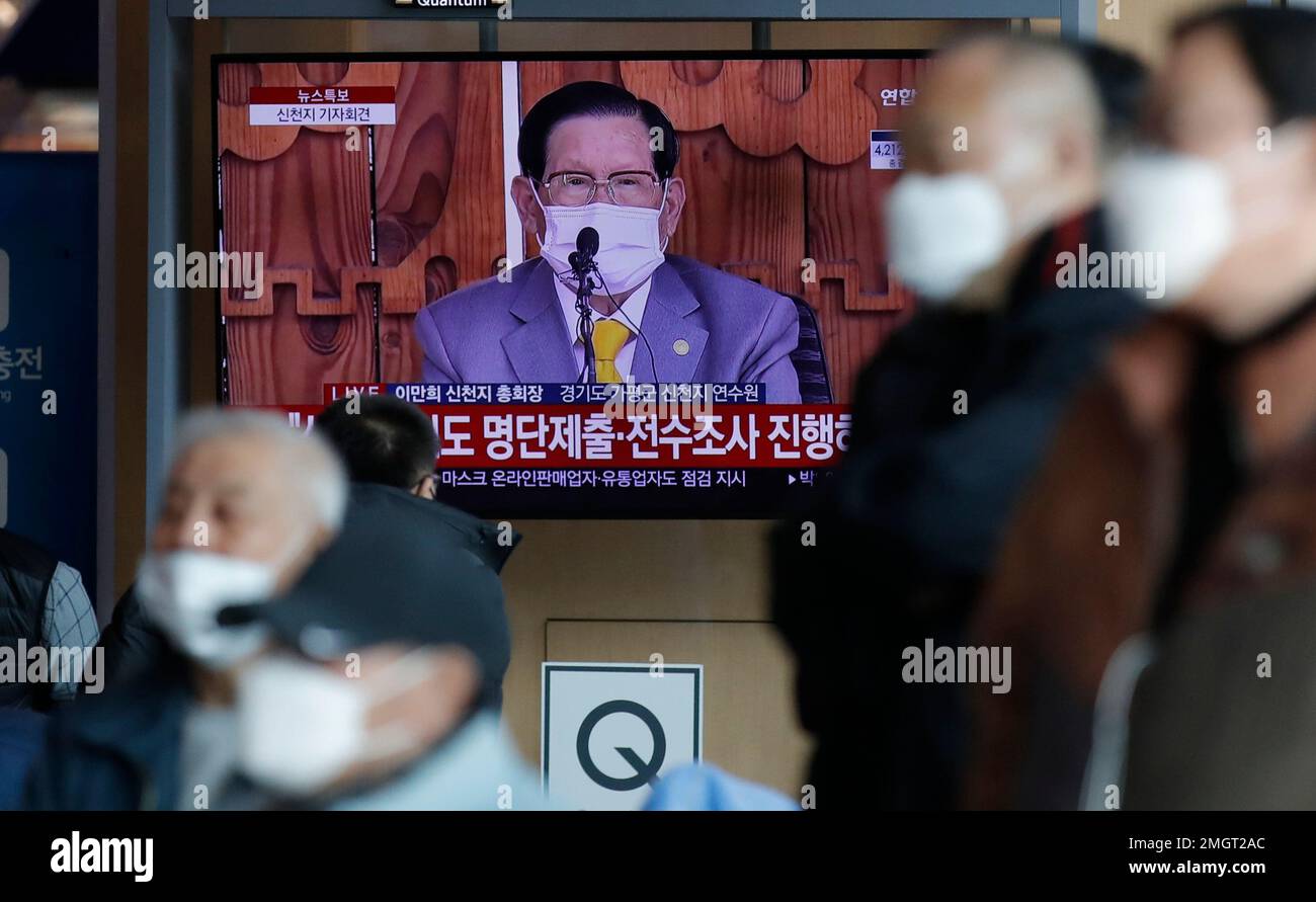 People watch a TV screen showing a live broadcast reporting about Lee ...