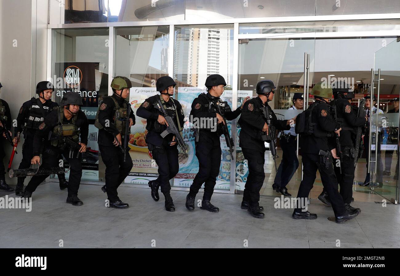 Police enter a mall in Manila, Philippines Monday, March 2, 2020 ...