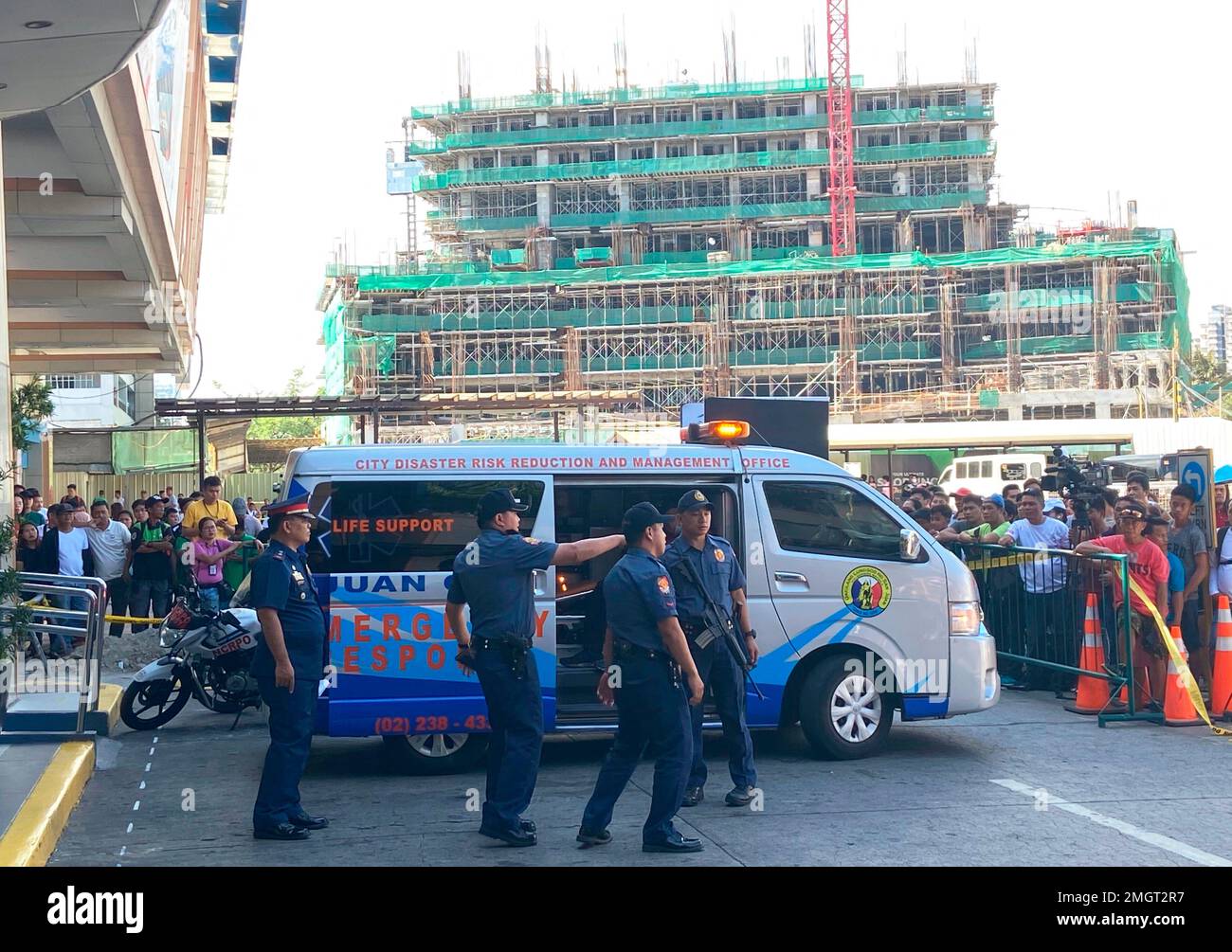 Security officers stand outside the V-Mall where gunshots rang out ...