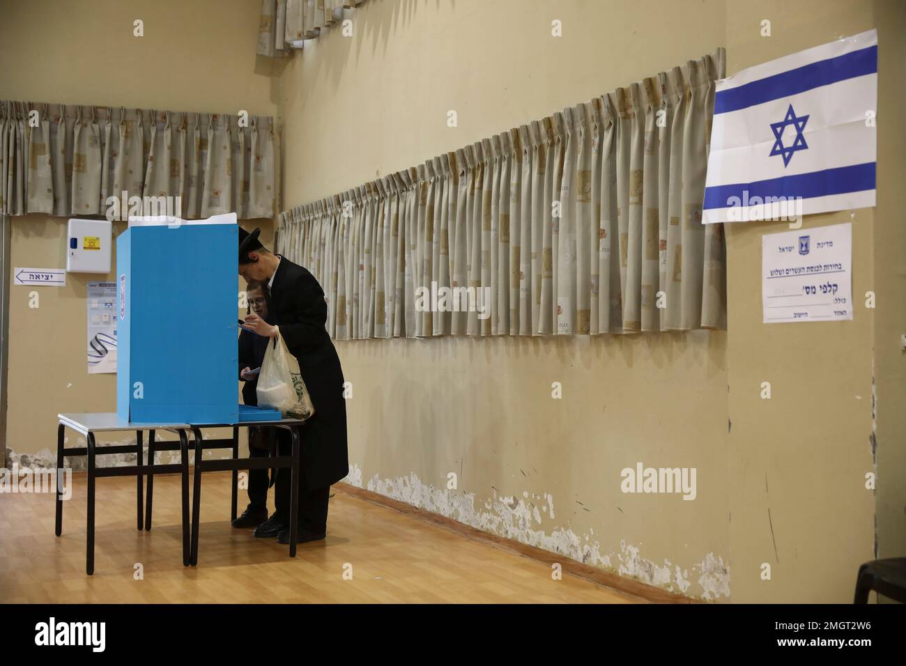 Ultra-orthodox man votes during elections in Bnei Brak, Israel, Monday ...