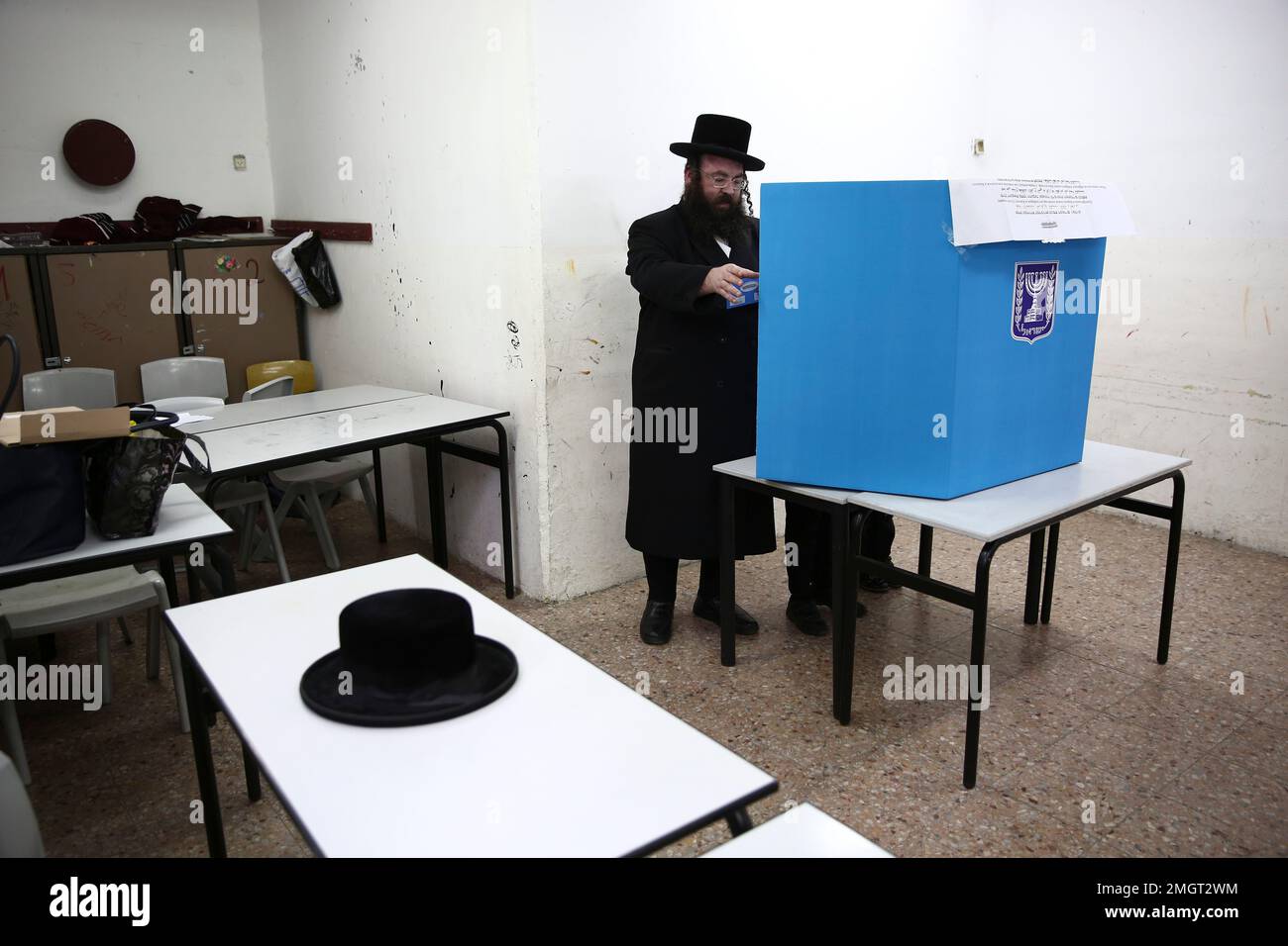 Ultra-orthodox man votes during elections in Bnei Brak, Israel, Monday ...