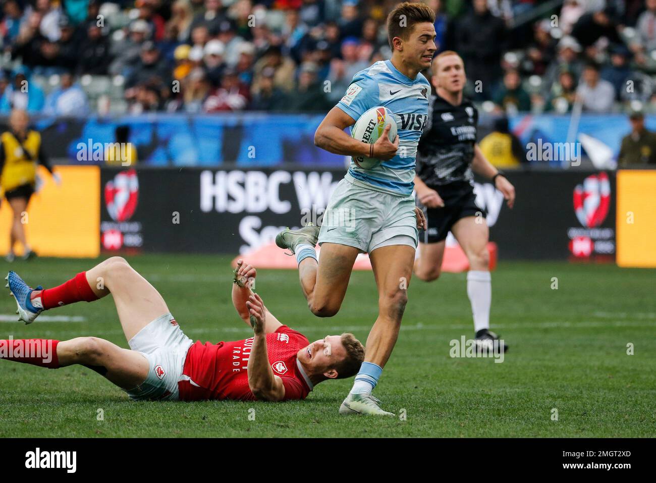 Argentina's Marcos Moneta, right, runs for a try past Canada's Conor ...