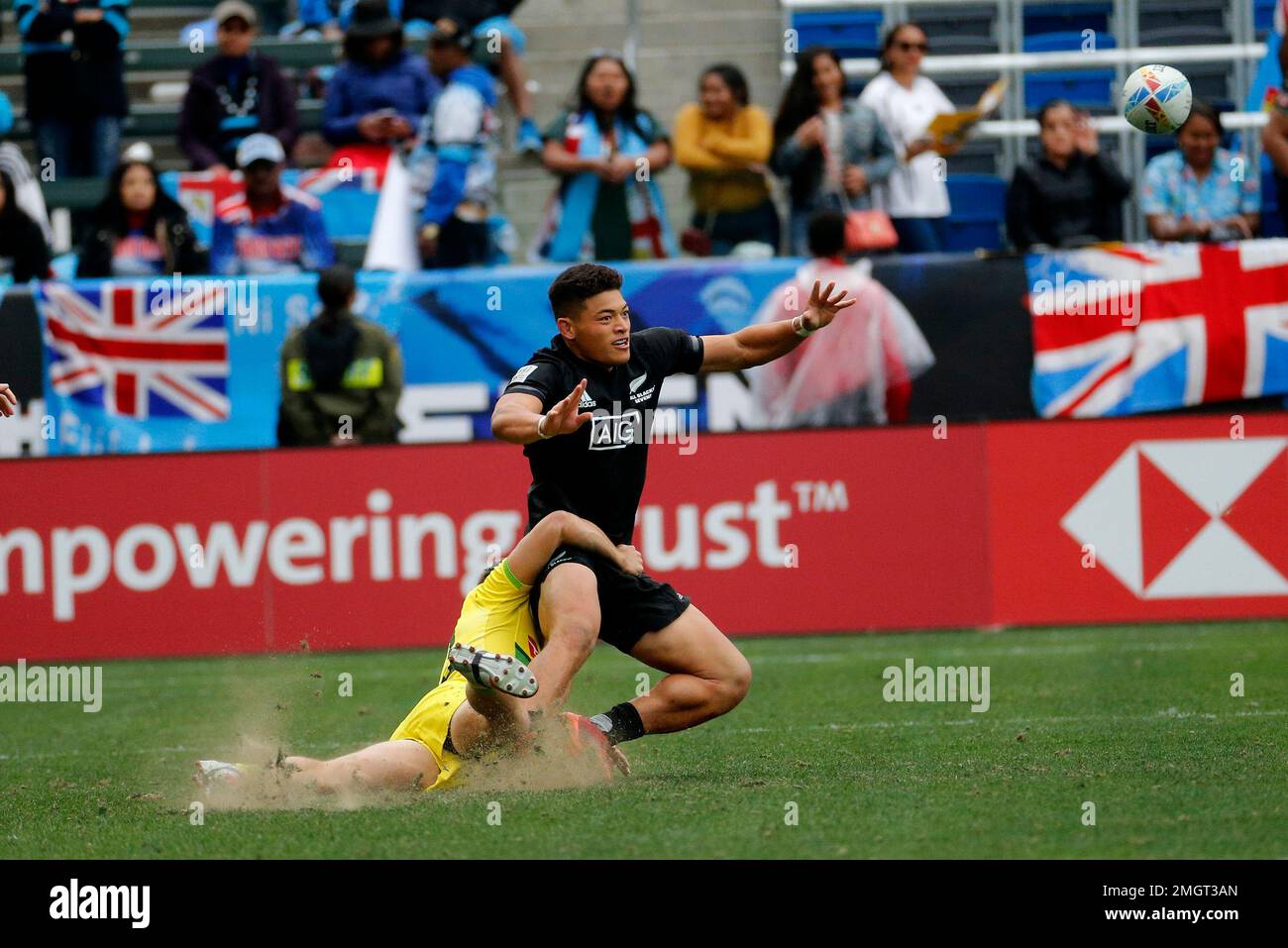 New Zealand's Tone Ng Shiu, right, passes the ball while tackled by ...