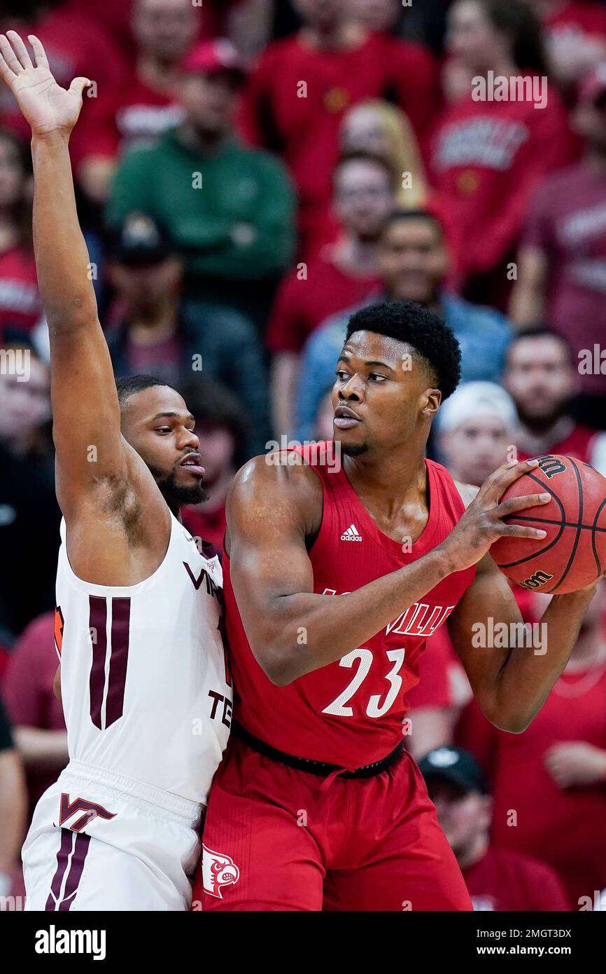 Louisville center Steven Enoch (23) passes the ball around Virginia ...