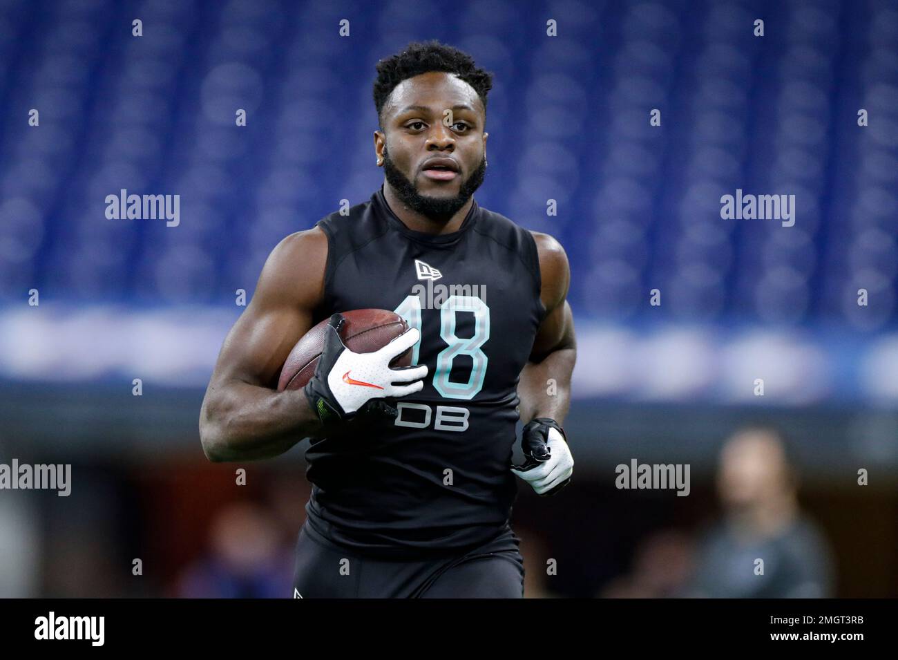 Auburn defensive back Noah Igbinoghene runs a drill at the NFL football scouting combine in ...