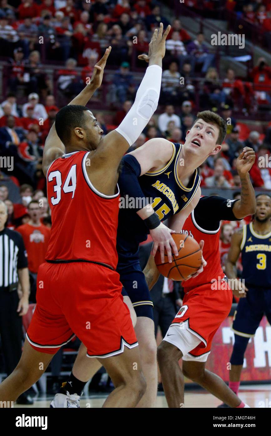 Michigan center Jon Teske, right, tries to get past Ohio State forward ...
