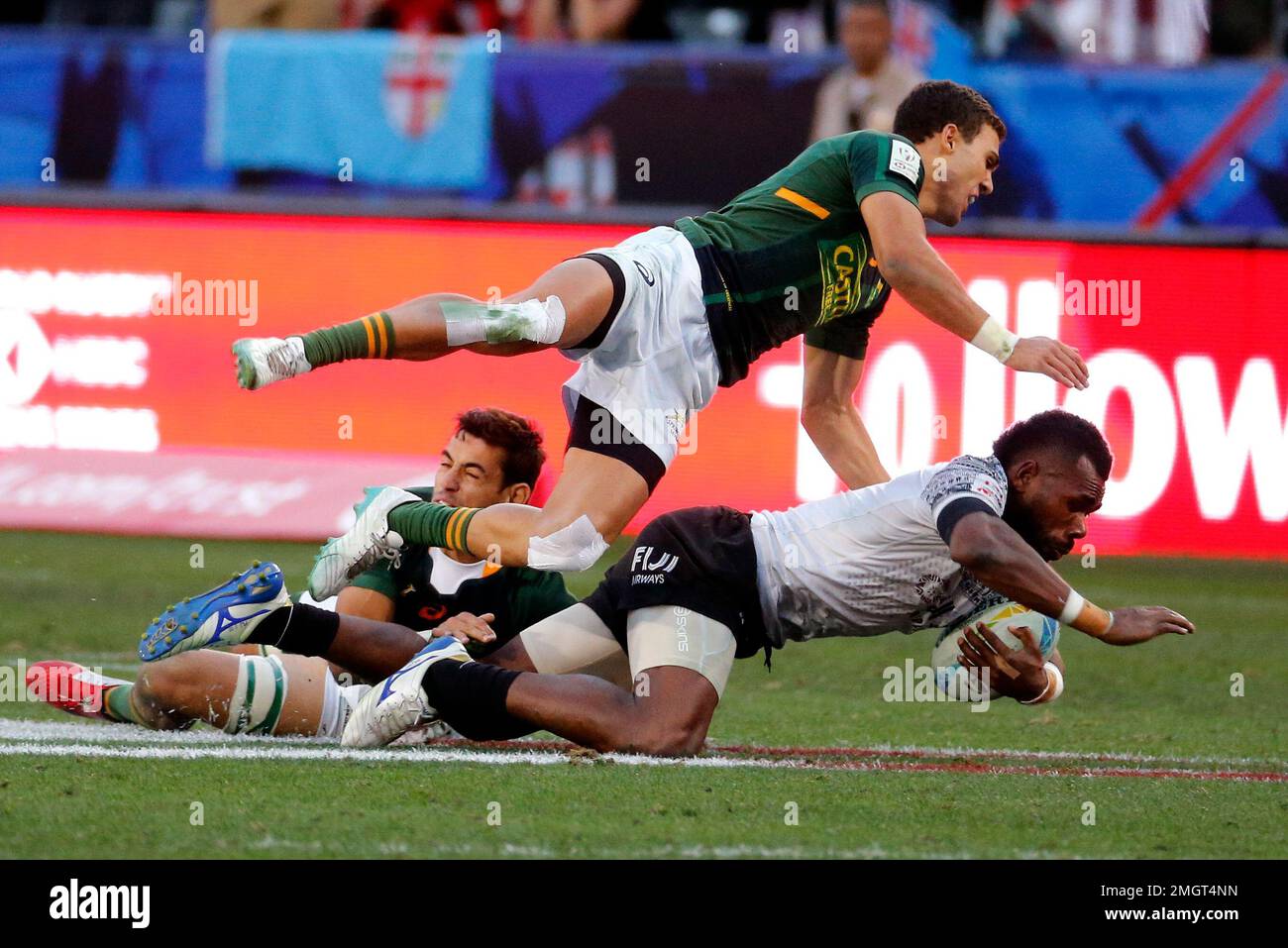 South Africa's Muller Du Plessis, top, flies over Fiji's Kavekini Tabu ...