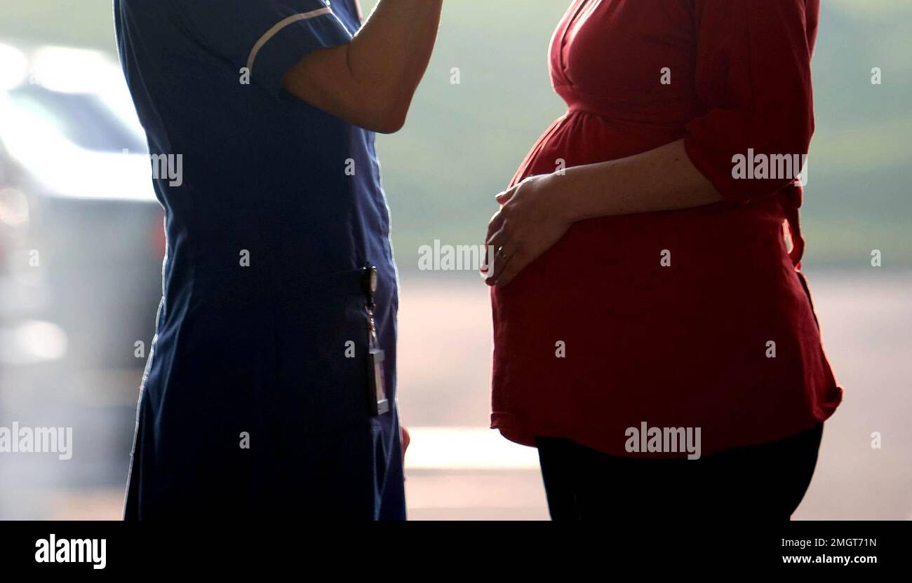 File photo dated 19/02/08 of a midwife talking to a pregnant woman. The ...