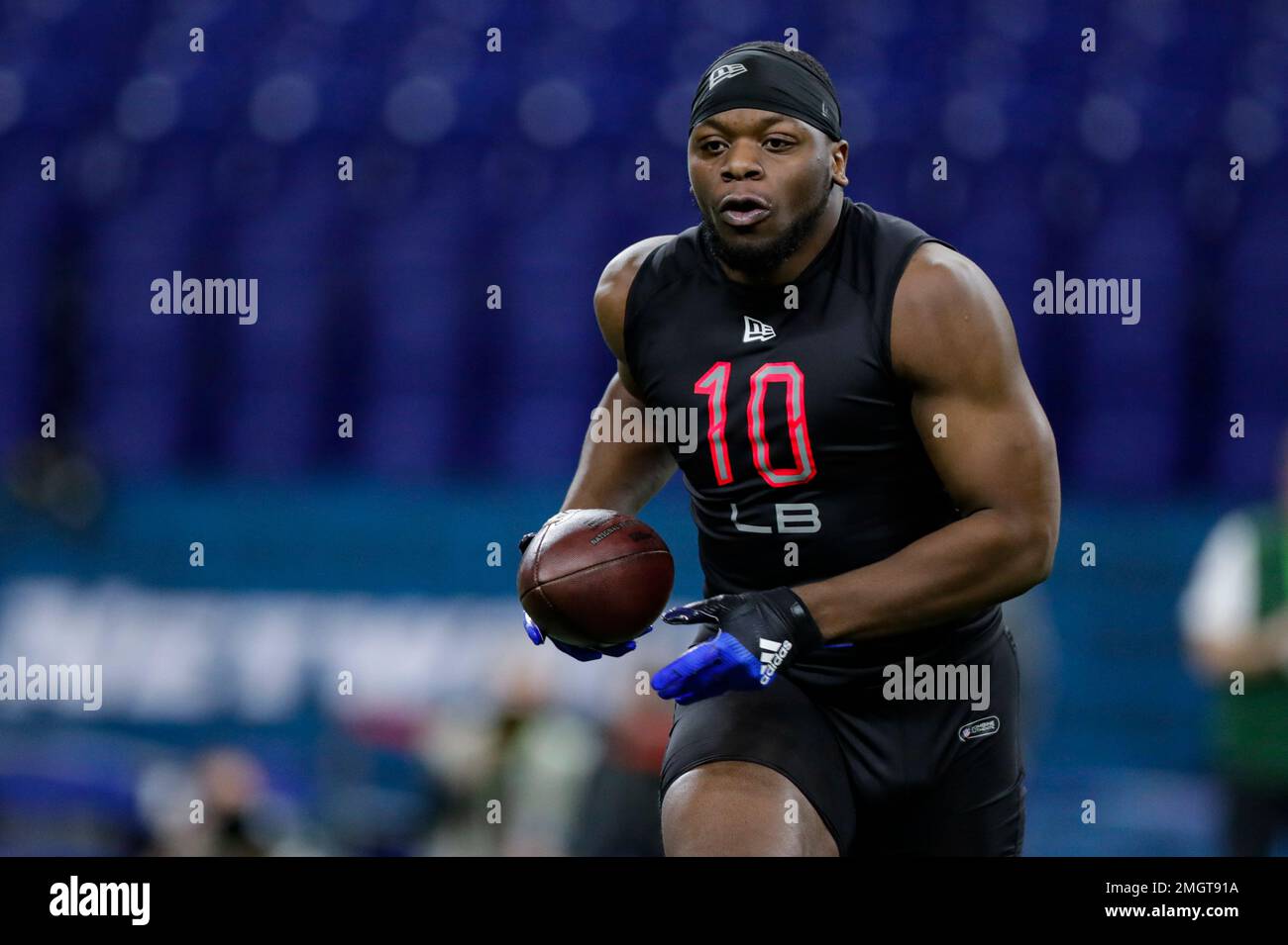 Auburn linebacker Nick Coe runs a drill at the NFL football scouting ...