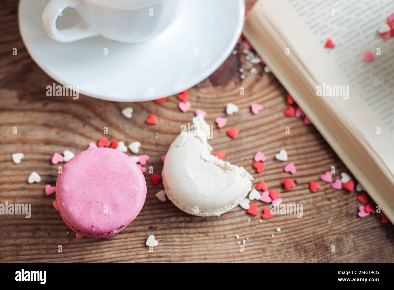 Lavender and almond macaroon with a bitten off piece on a wooden ...