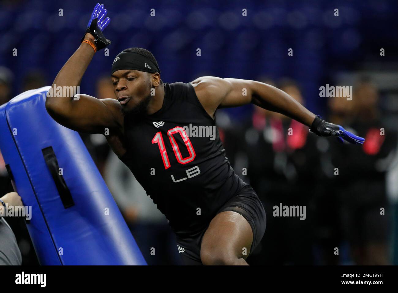 Auburn linebacker Nick Coe runs a drill at the NFL football scouting ...