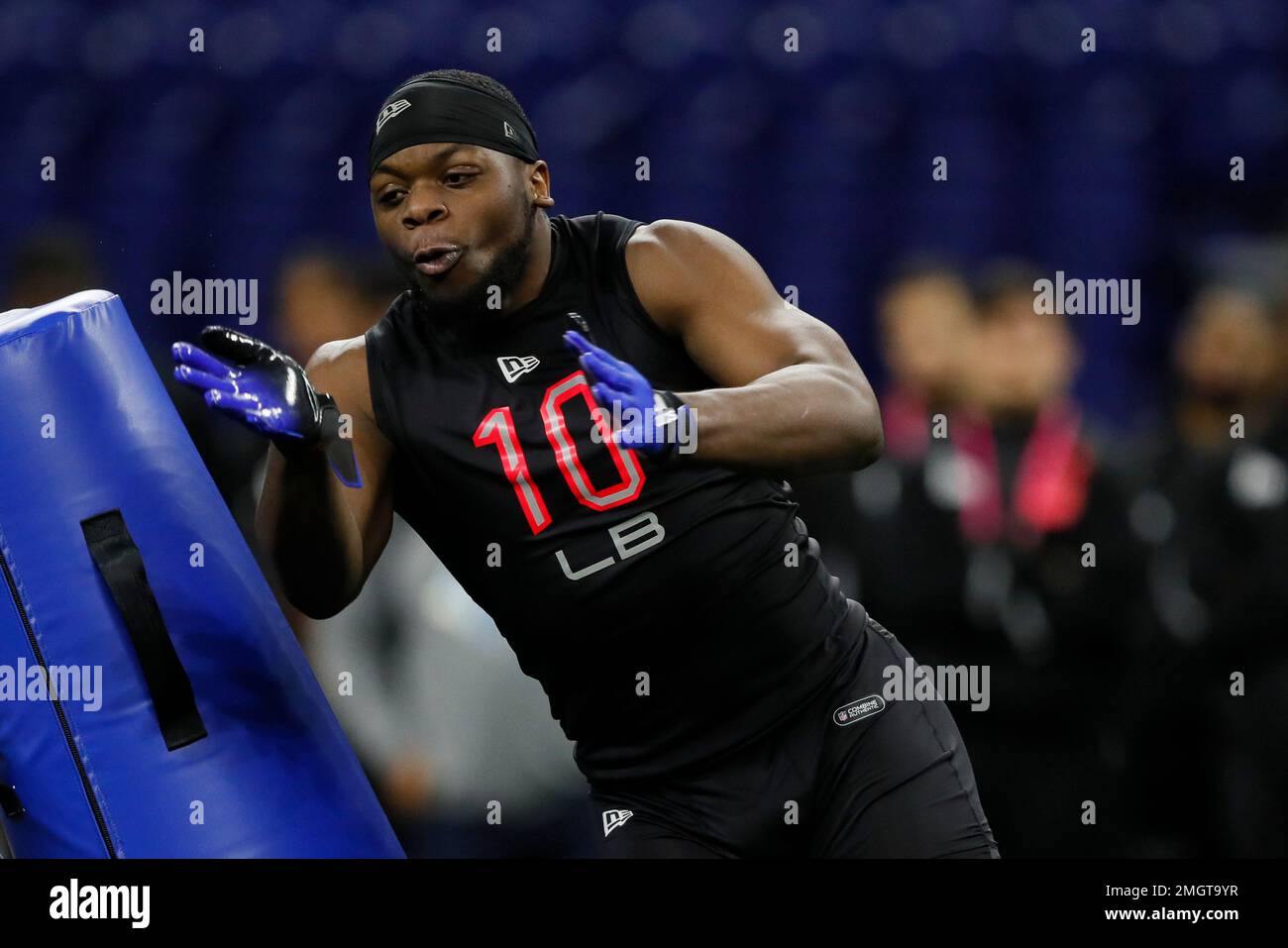 Auburn linebacker Nick Coe runs a drill at the NFL football scouting ...