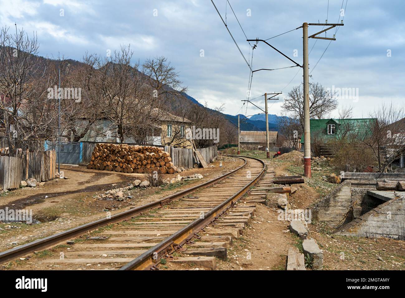 railroad track along the residential buildings in the village Stock ...