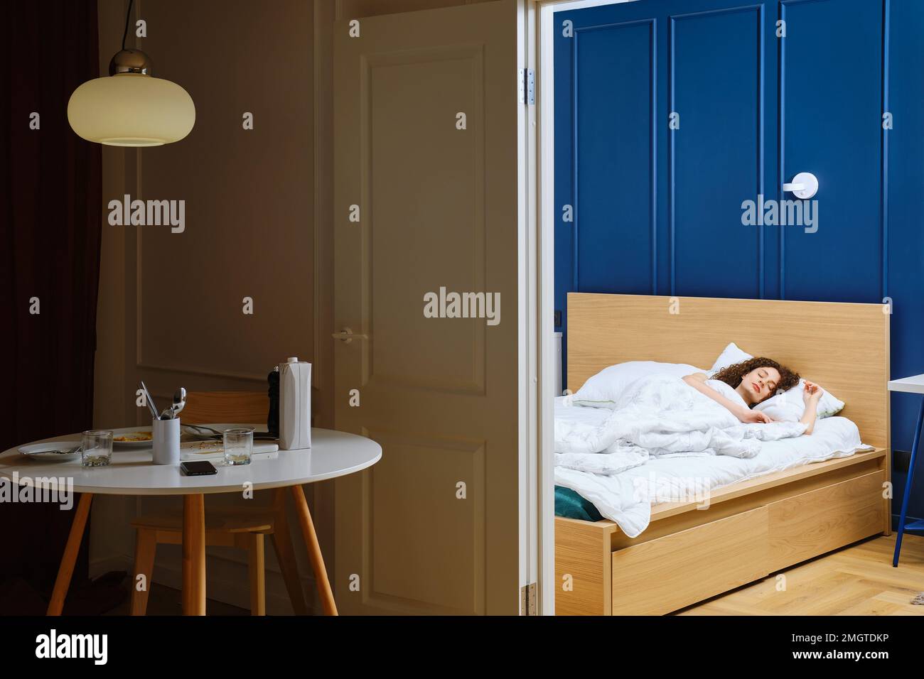 Tired woman fell asleep forgotten to switch off the light Stock Photo ...