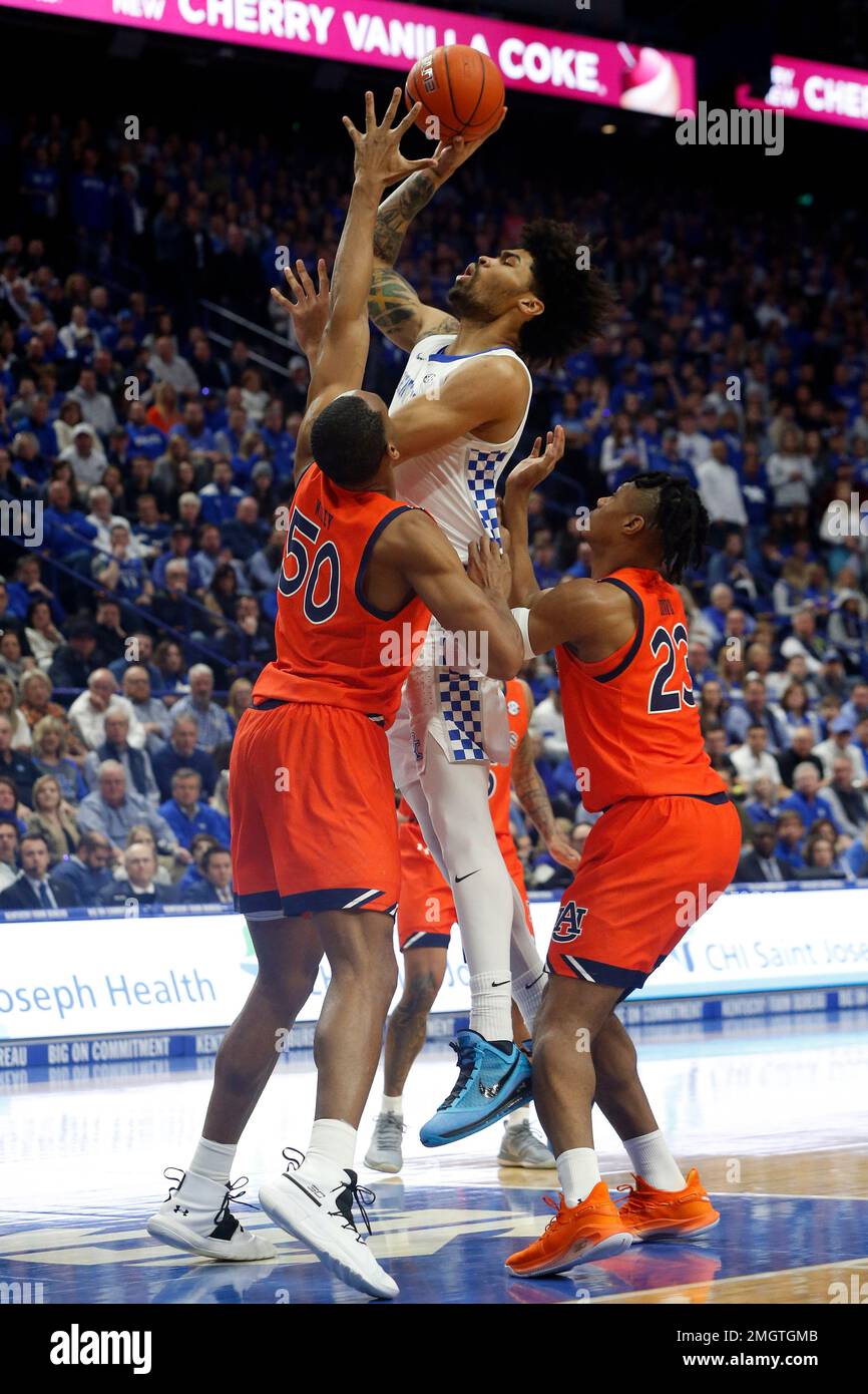 Kentucky's Nick Richards, top, shoots while defended by Auburn's Austin ...