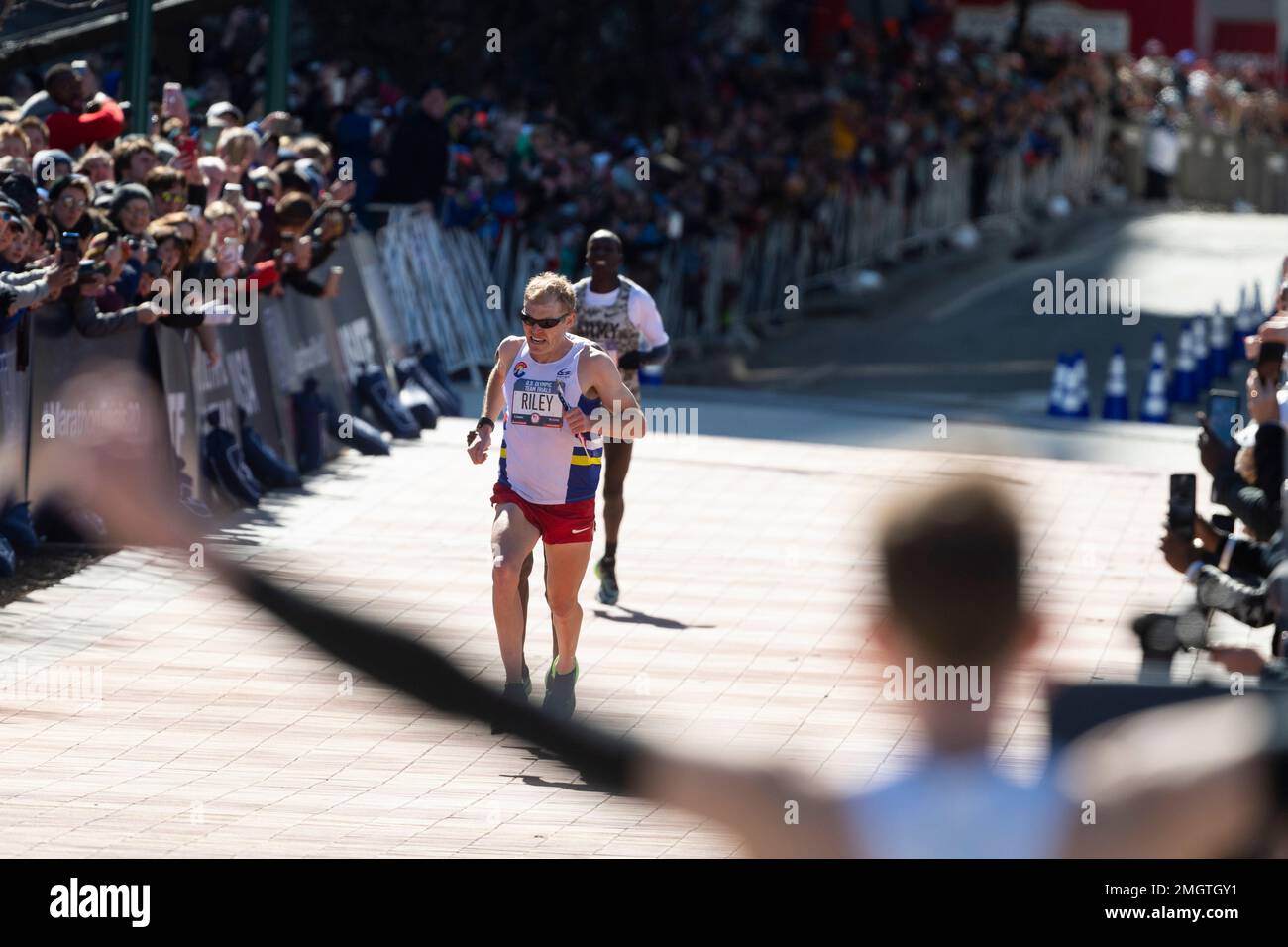 Second-place finisher Jacob Riley, is followed by third-place finisher ...
