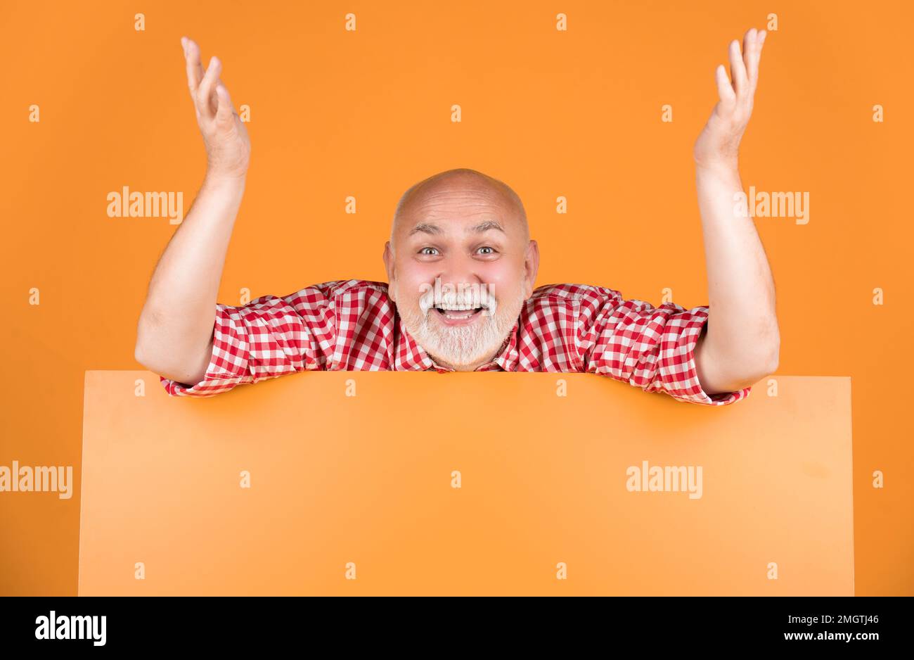 surprised senior man with copy space on blank banner. advertisement ...