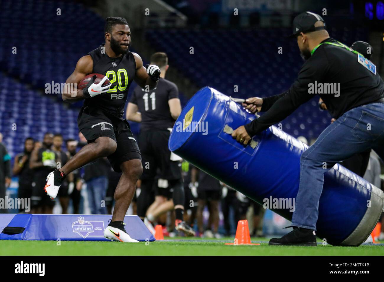 Utah running back Zack Moss runs a drill at the NFL football scouting ...