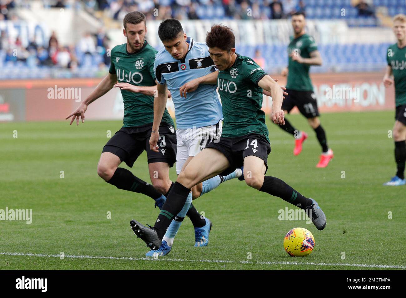 Lazio's Joaquin Correa, center, challenges for the ball with Bologna's ...