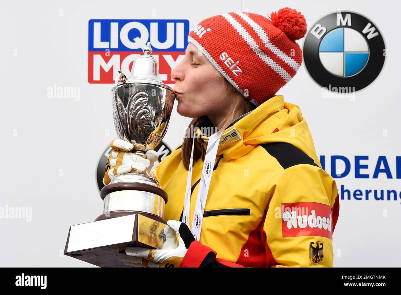 Winner Tina Hermann of Germany kisses the trophy on the podium during ...